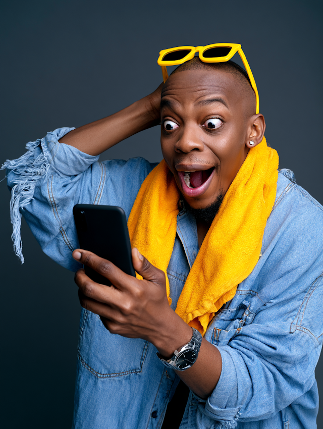 Free: Joyful Young Man with Smartphone in Studio - nohat.cc